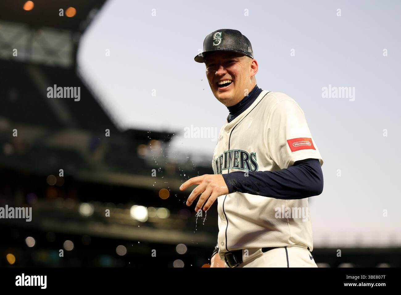 Seattle Mariners starting pitcher Logan Evans reacts after being dunked ...