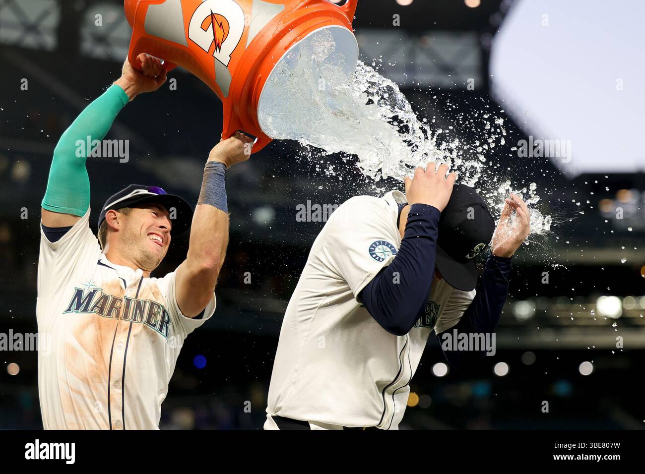 Seattle Mariners starting pitcher Logan Evans is dunked with water by ...