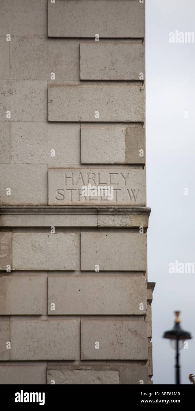 Close-up of the Harley Street sign on a brick wall corner in London. A ...