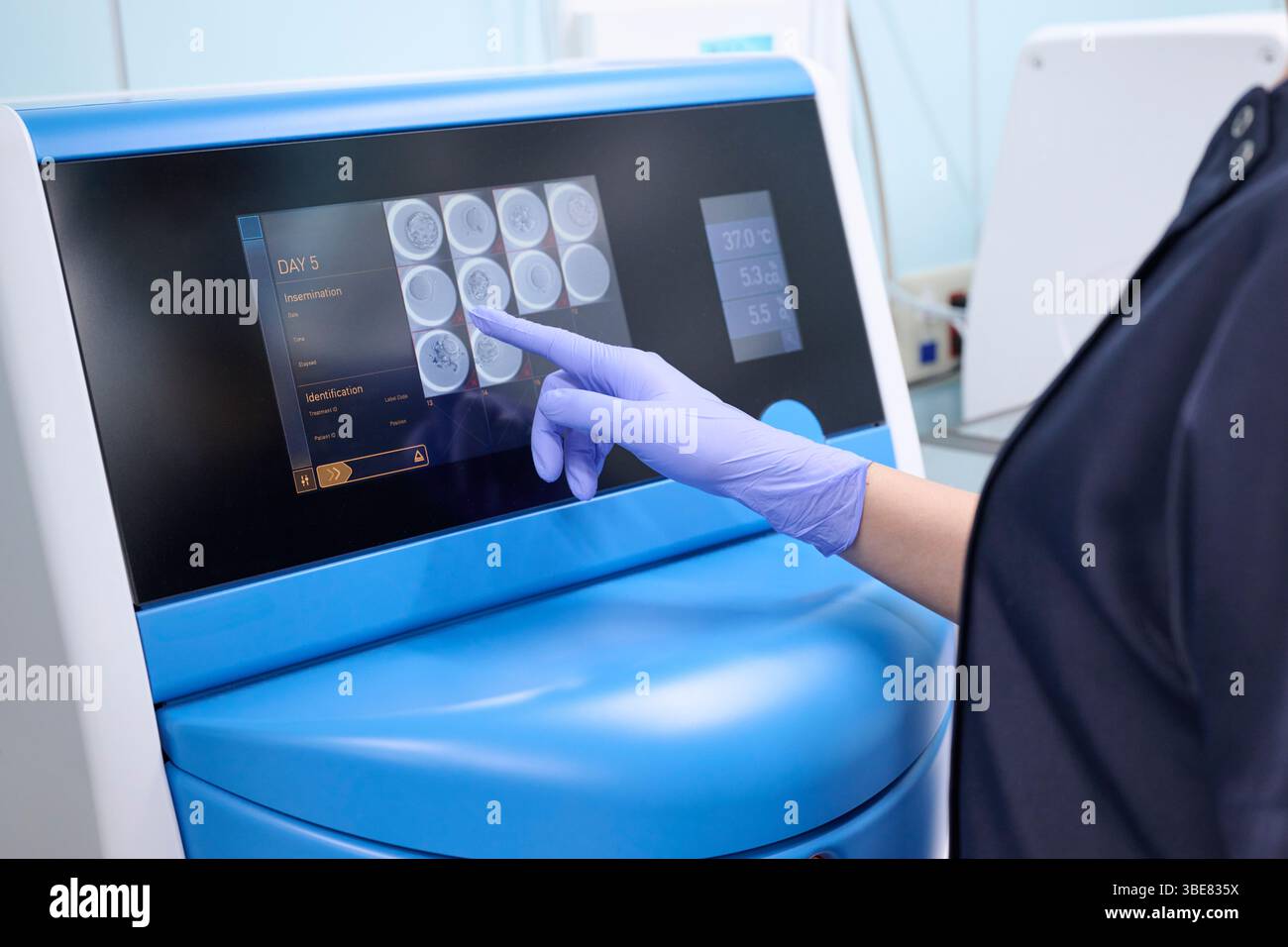 An embryologist observes a fertilised egg in an incubator Stock Photo ...