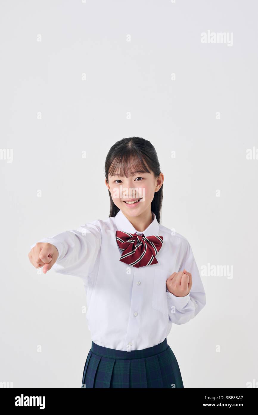 Japanese junior high school girl posing for a fight on white background ...