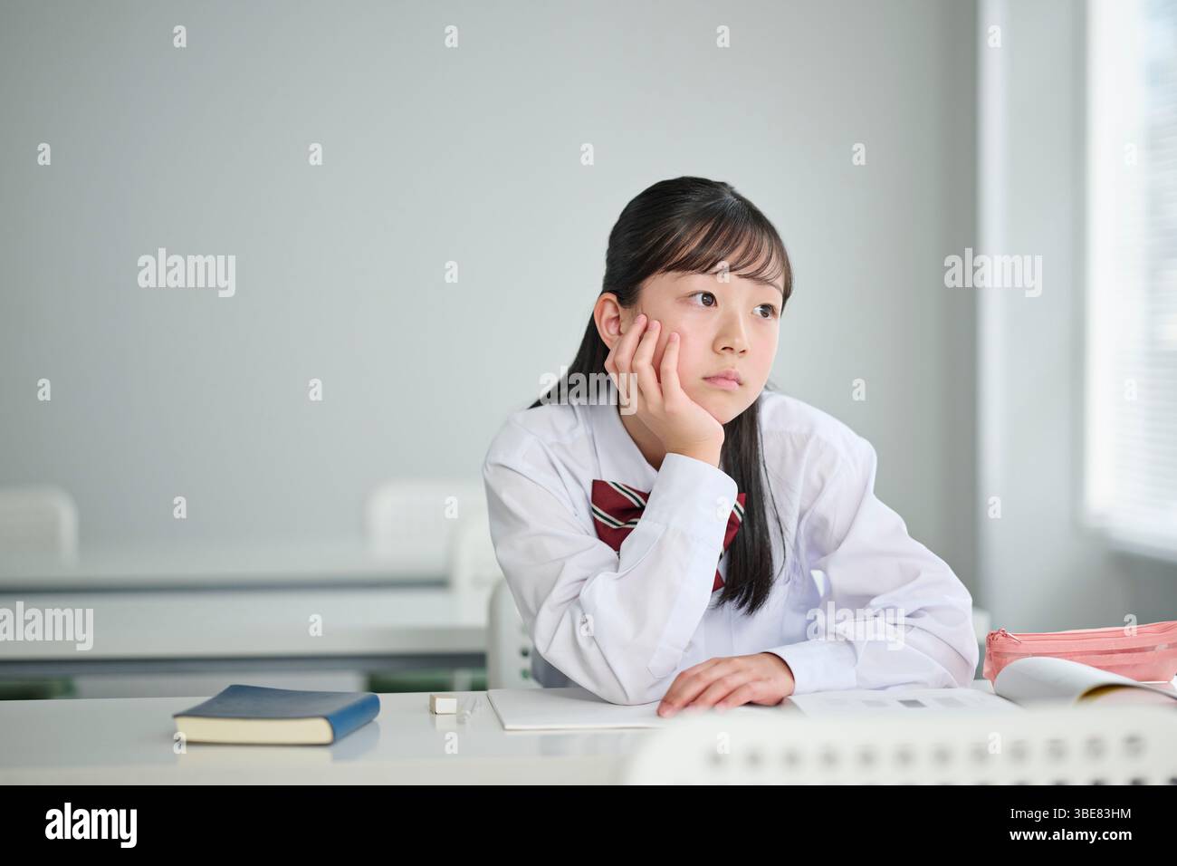Junior high school girls thinking in a classroom Stock Photo - Alamy