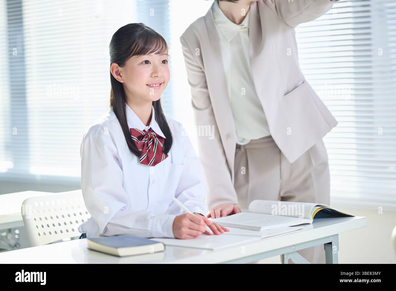 A junior high school girl is taught by a tutoring teacher Stock Photo ...