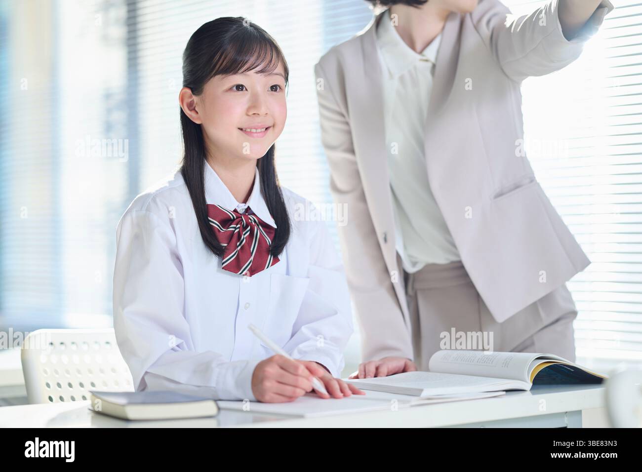 Junior high school girl studying with a tutoring teacher Stock Photo - Alamy