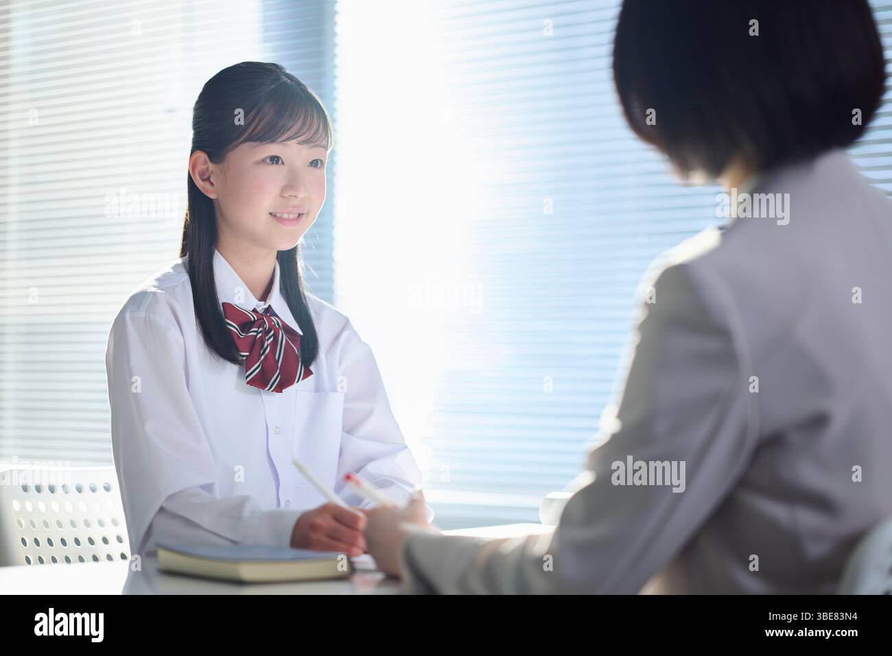 Junior high school girl studying with a tutoring teacher Stock Photo ...