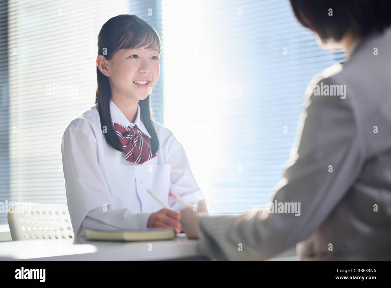 Junior high school girl studying with a tutoring teacher Stock Photo ...