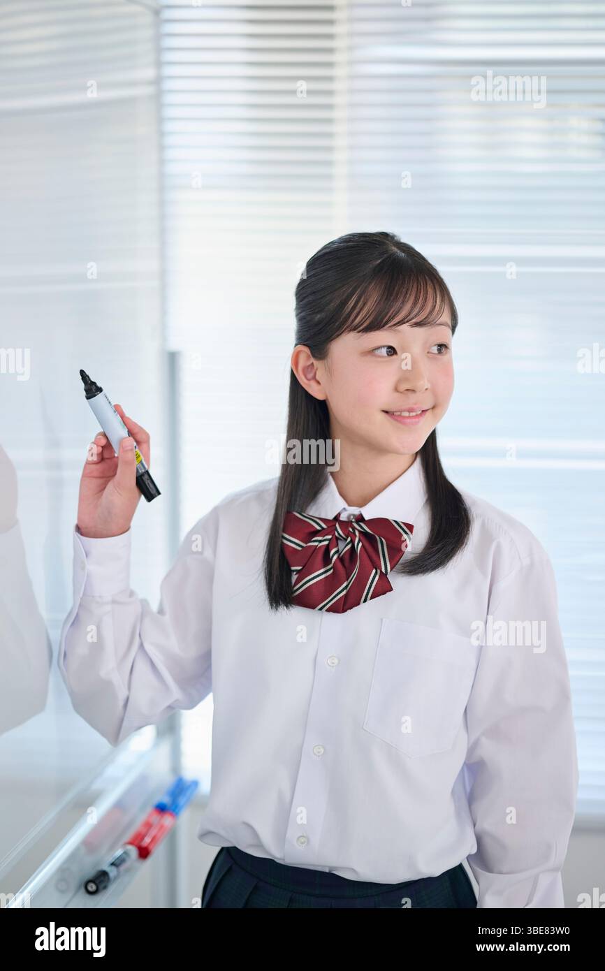Junior high school girls giving a presentation in class Stock Photo - Alamy