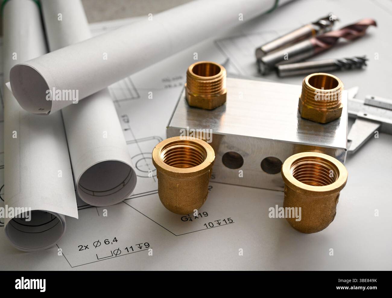 Plumbing project showing manifold, fittings, blueprint and end mills ...