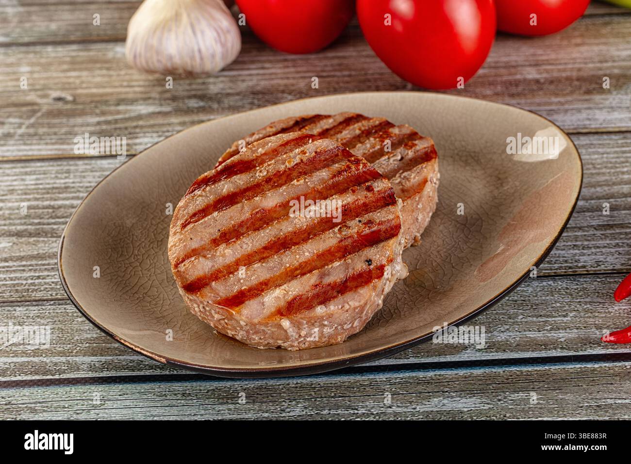 Grilled tuna steak fillet round medallion Stock Photo - Alamy