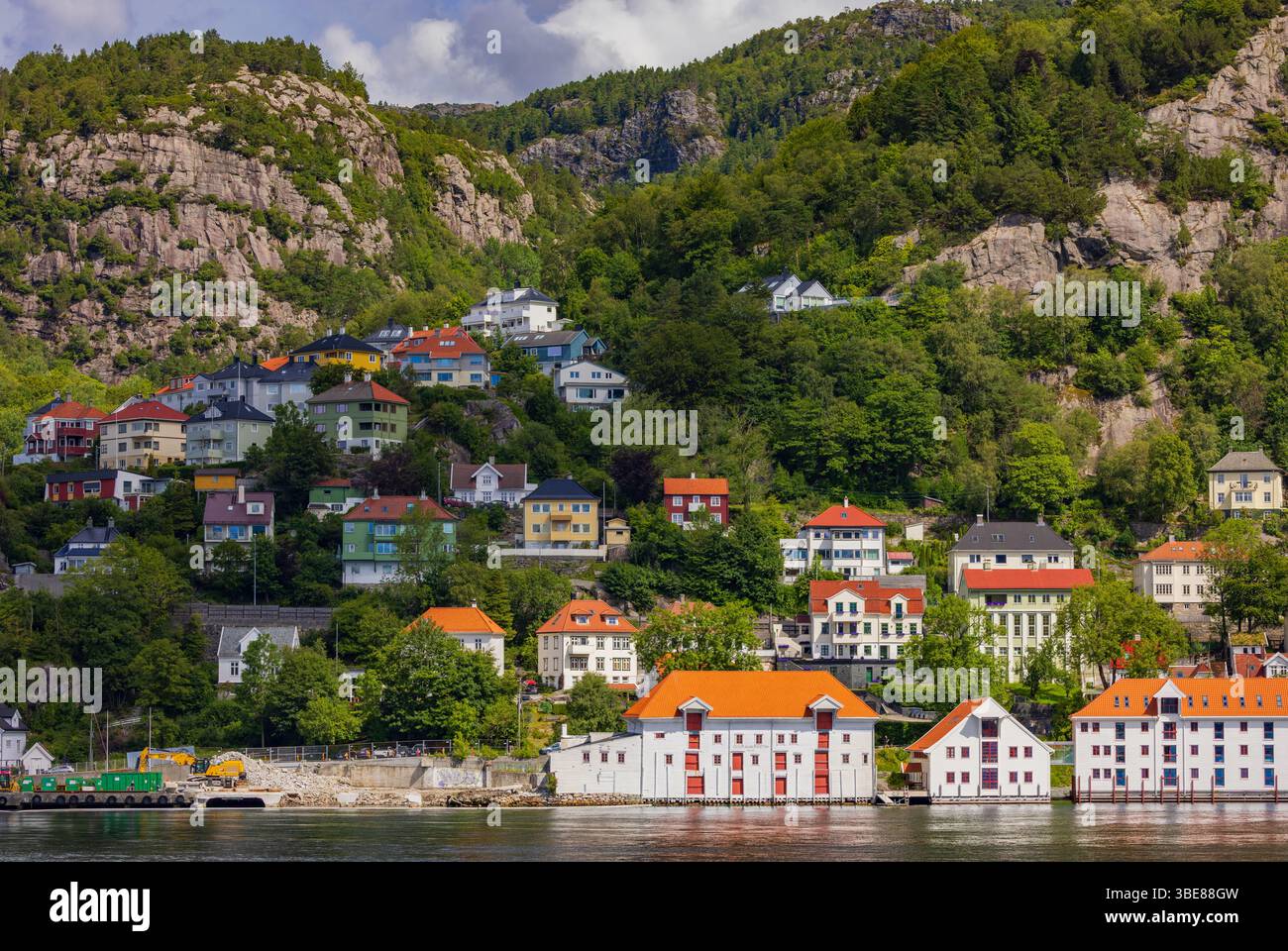 Vibrant Norwegian hillside homes with red rooftops rising from the ...