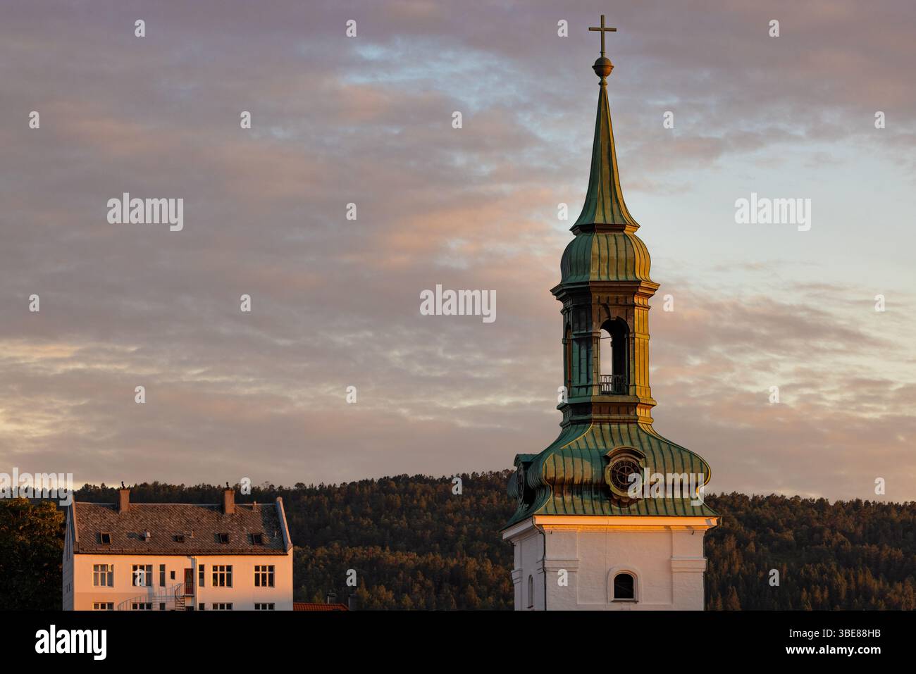 Historic copper-roofed church tower in Norway illuminated by golden ...