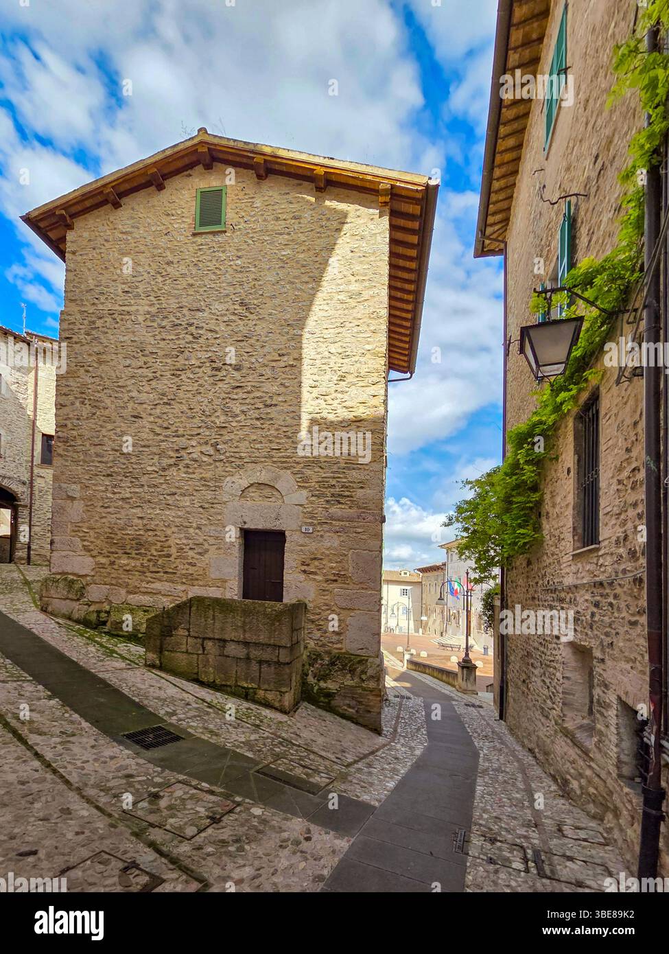 A narrow street among the ancient buildings of Spoleto, a medieval town ...