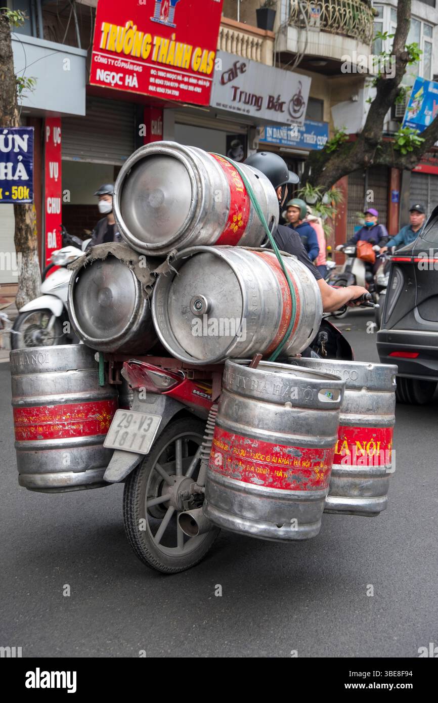 Motorcycle overloaded with jerry cans on the city streets in Hanoi ...