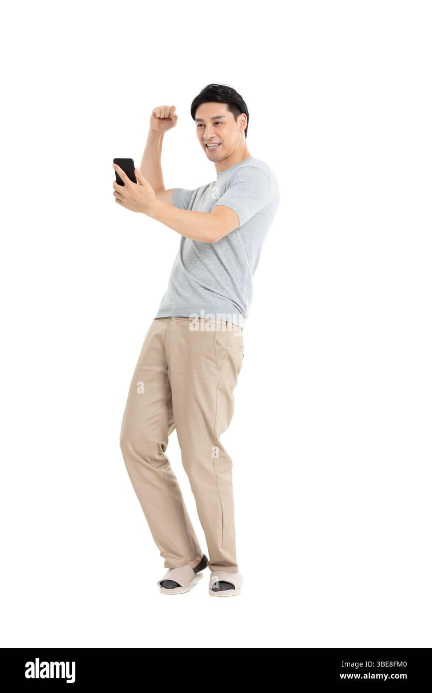 A young man staring at his phone screen, absolutely thrilled with his ...