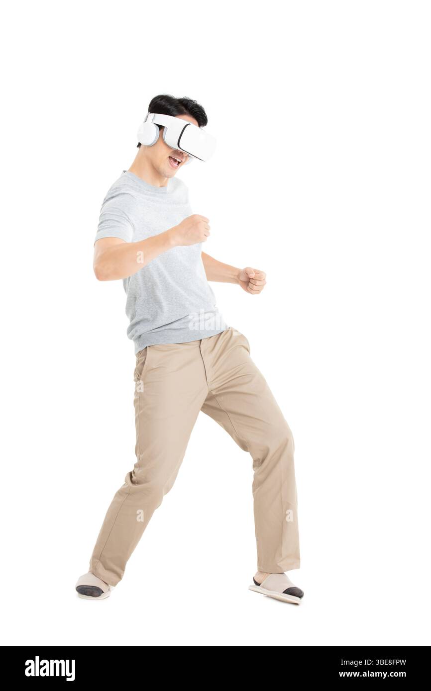 A young man wearing a VR headset, engaged in immersive human-machine ...