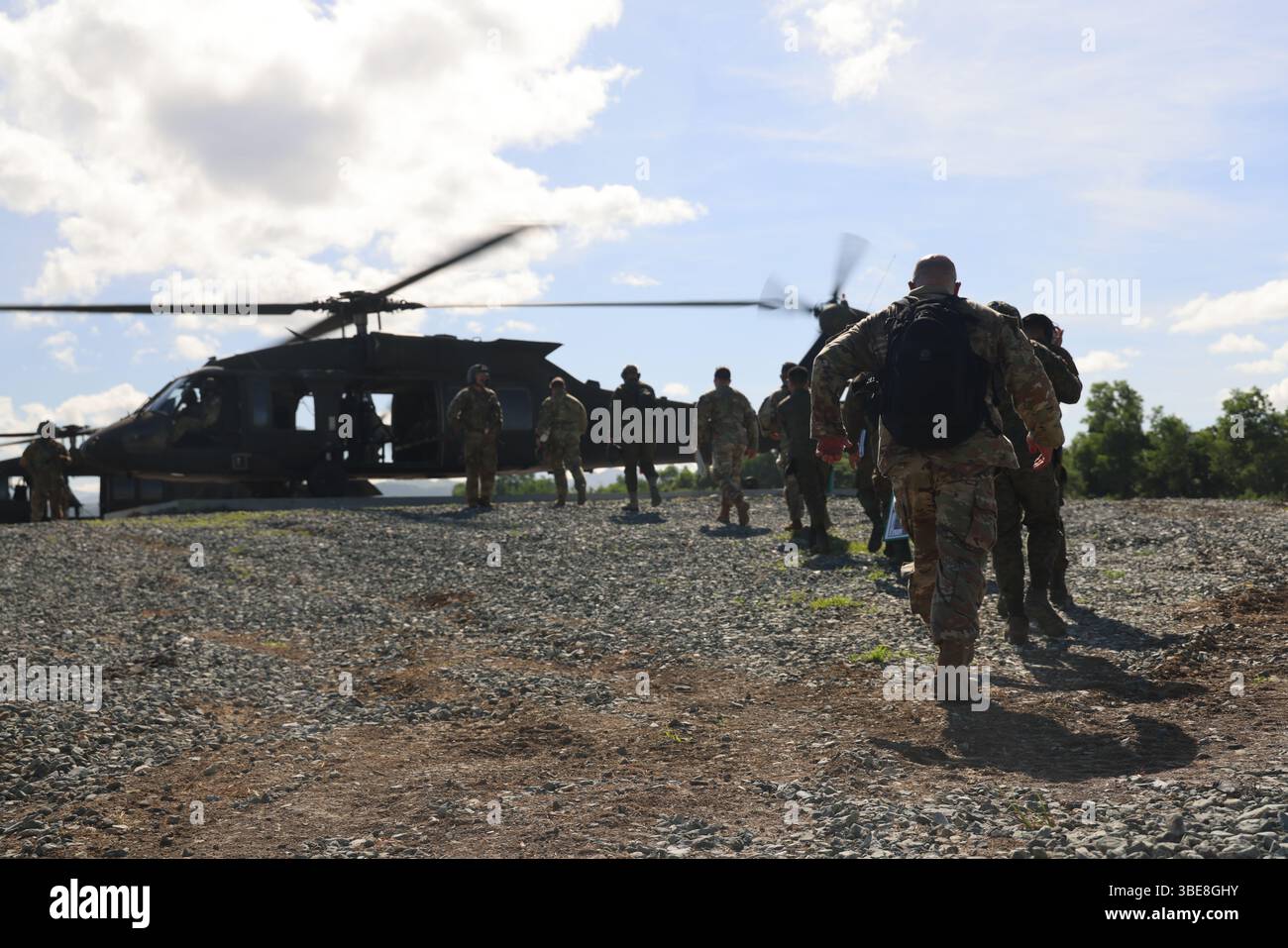 Philippine and U.S. Army leaders walk toward a Black Hawk helicopter at ...