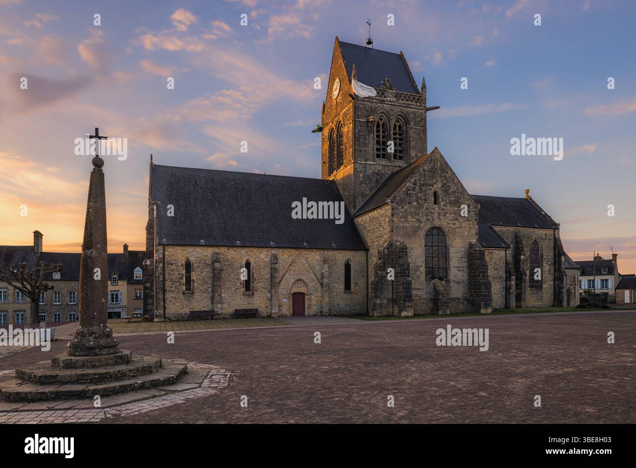Sunset at the Gothic church of Sainte-Mère-Église in Normandy with a ...
