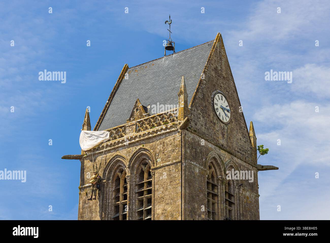 Sunset at the Gothic church of Sainte-Mère-Église in Normandy with a ...