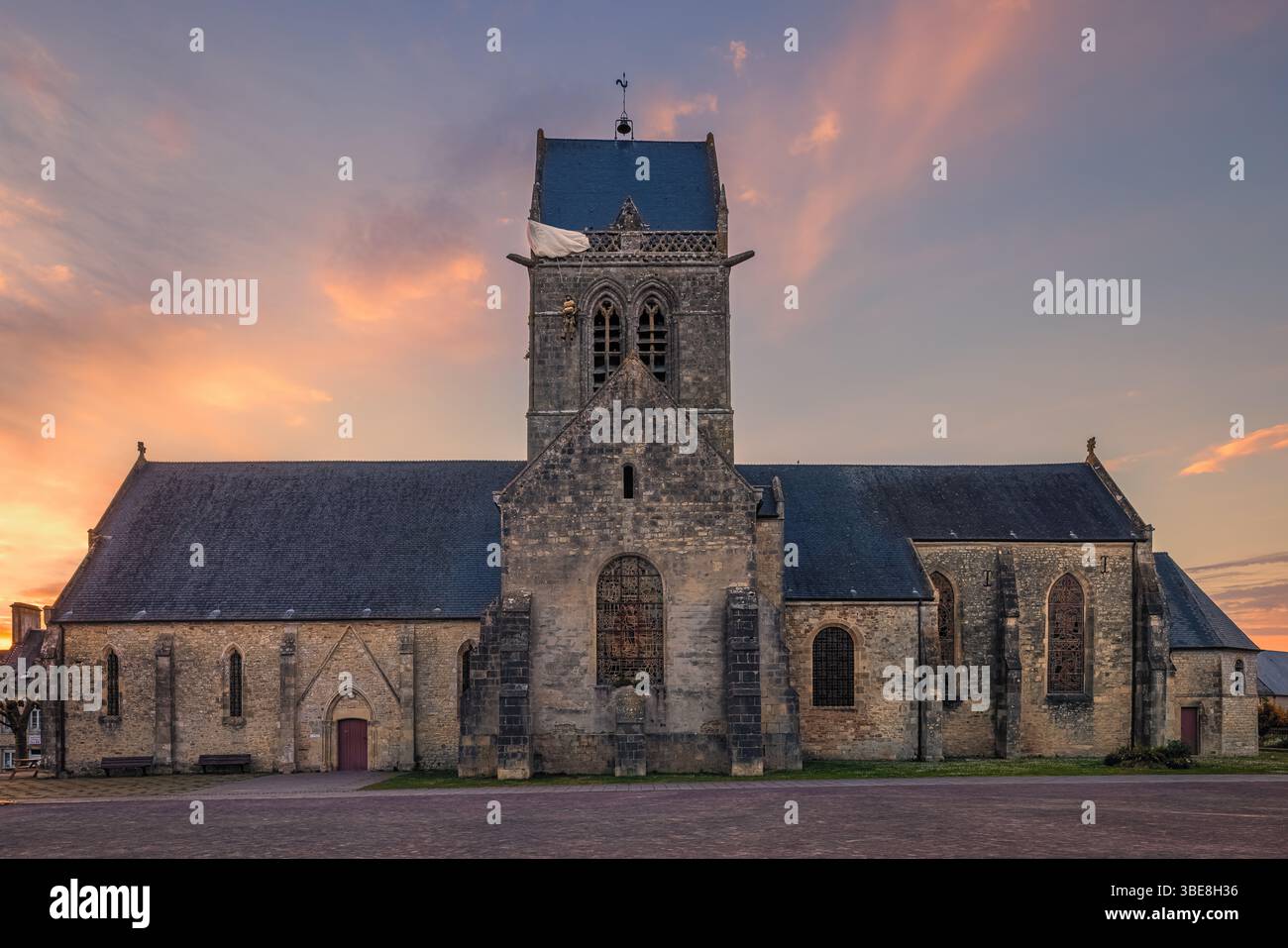 Sunset at the Gothic church of Sainte-Mère-Église in Normandy with a ...