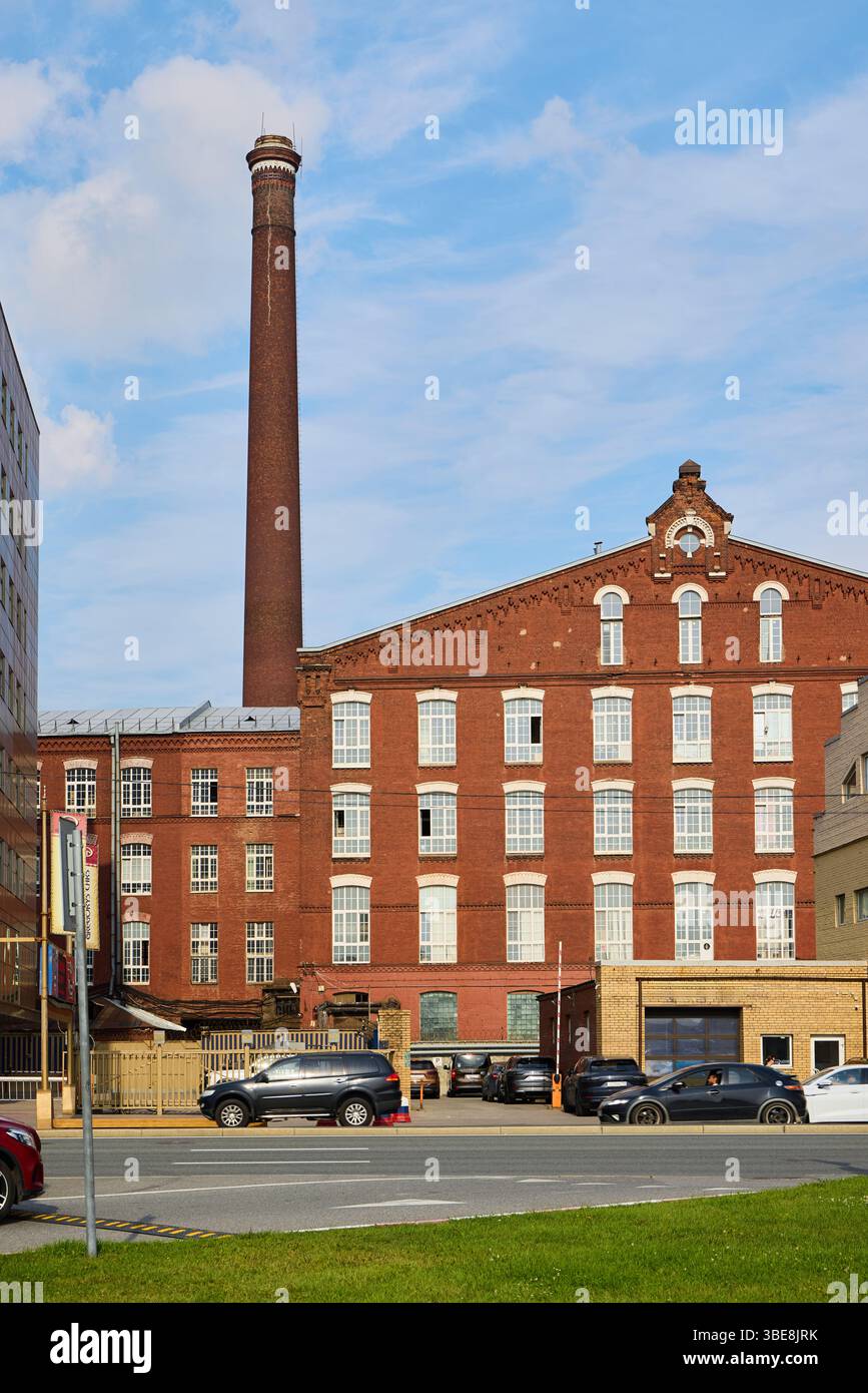 An Historic Red Brick Factory Featuring a Tall Chimney Set Against a ...