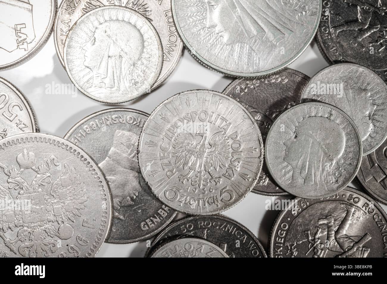 Various Polish coins lie on a reflective surface, showcasing intricate ...