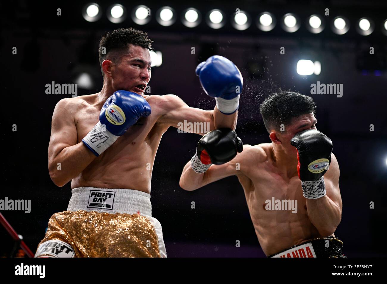 Champion Shu Utsuki (black gloves) of Japan and challenger Aketelieti Yelejian (blue gloves) of ...