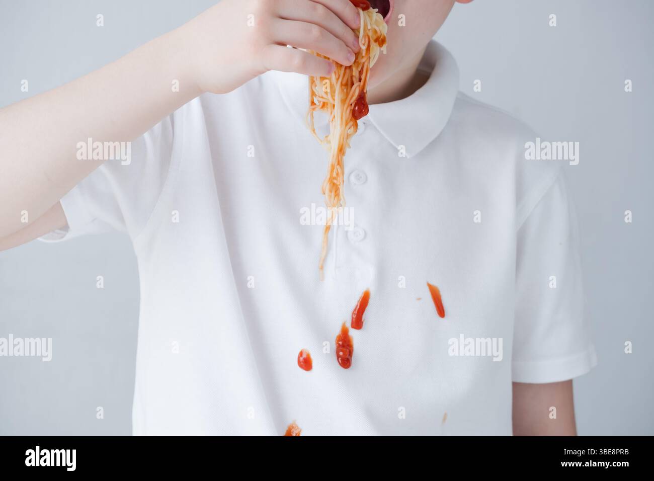 Spilled tomato sauce or ketchup stain on white clothes during lunch ...