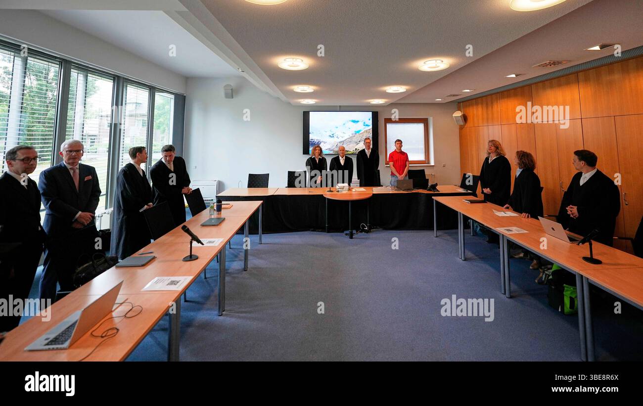 Presiding Judge Rolf Meyer, center, stands in front of a picture of a ...