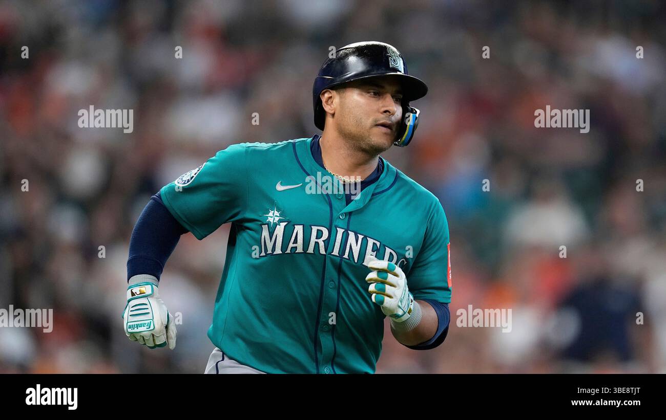 Seattle Mariners' Donovan Solano runs up the first base line against ...