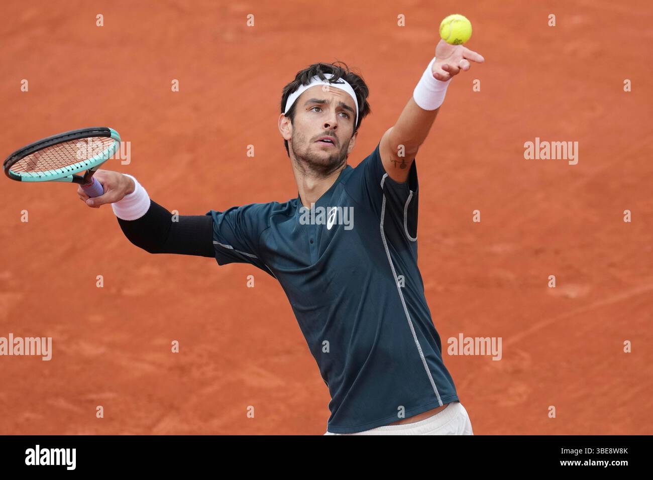 Italy's Lorenzo Musetti serves against Colombia's Daniel Elahi Galan during their second round ...