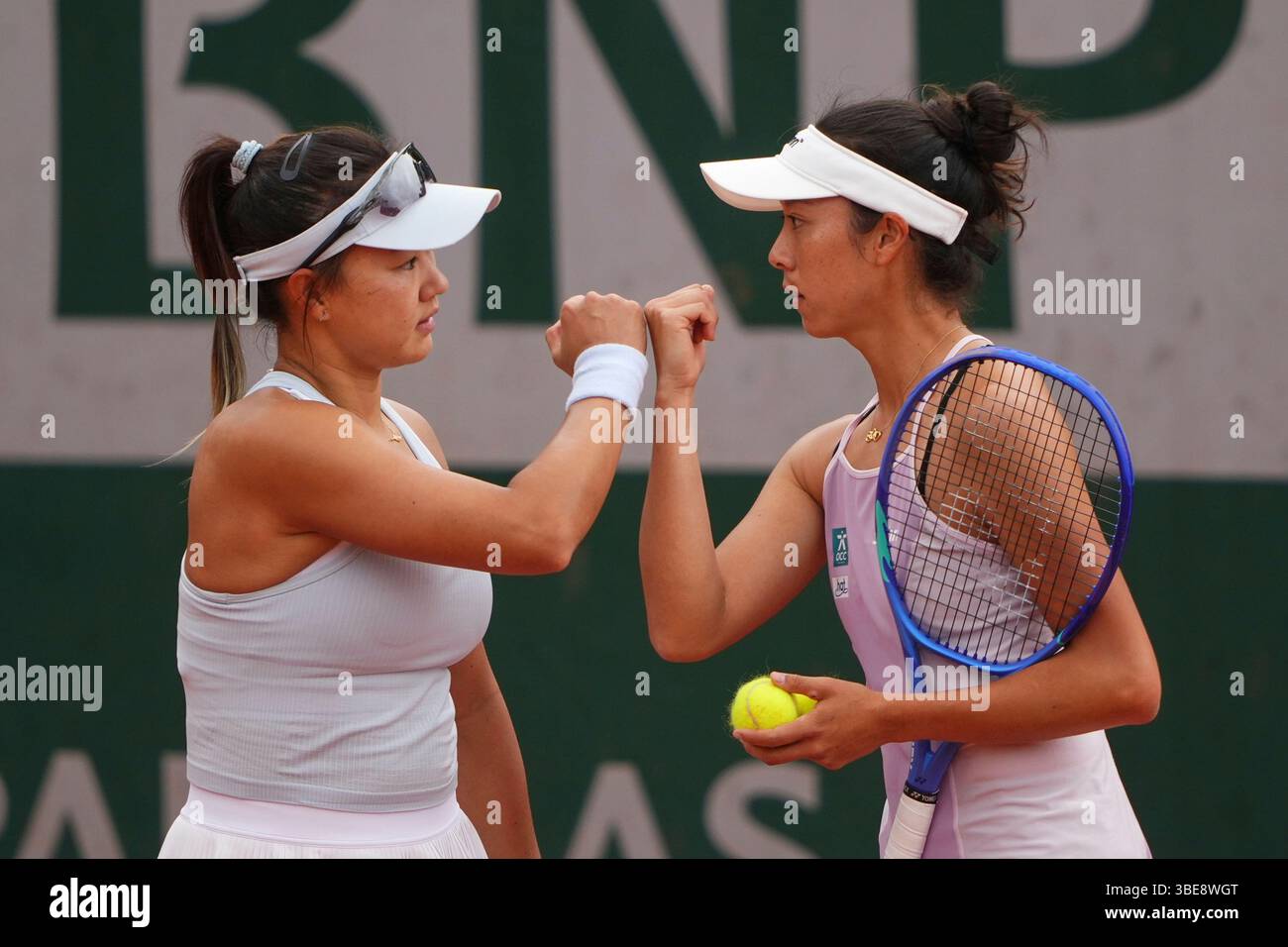 China's Guo Hanyu, left, and Japan's Ena Shibahara congratulate each ...