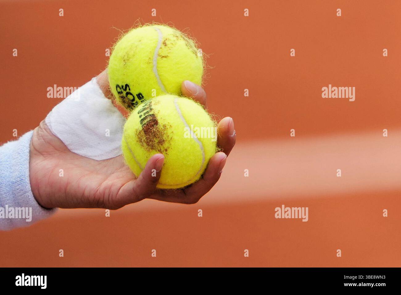 China's Guo Hanyu holds two balls as she plays Britain's Jodie Burrage ...