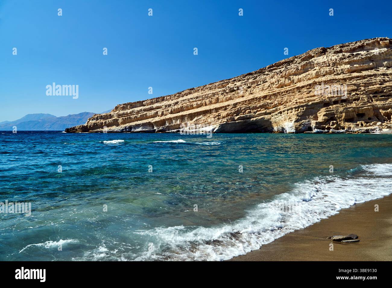 craggy rock above sandy beach of Matala on the island of Crete, Greece ...