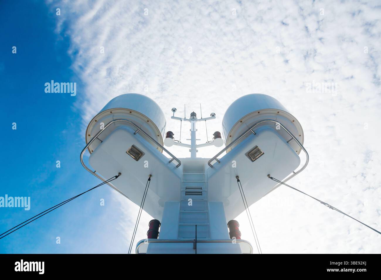 The mast of a large yacht with navigation equipment bottom view. Radar ...