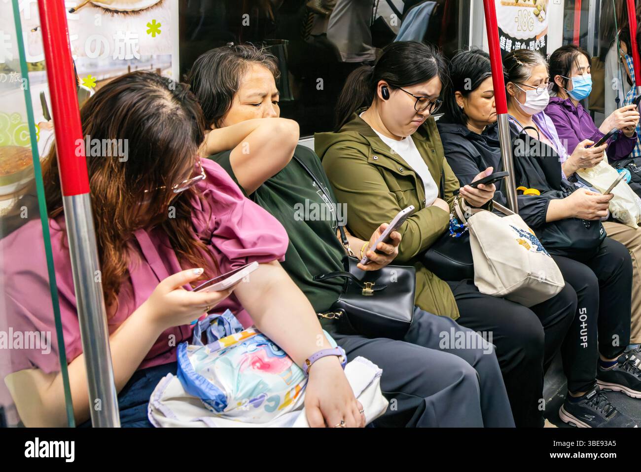 Passengers and train interior on MTR underground subway line, Hong Kong ...