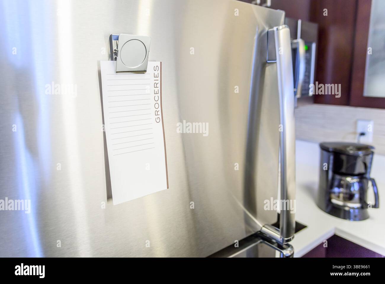 Glose up of a blank grocery shopping list on the door of stainless ...