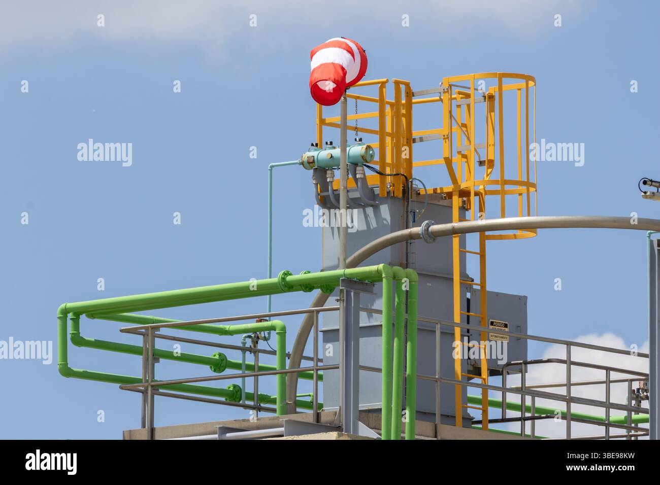Red and white windsock indicating wind direction, attached to metal ...