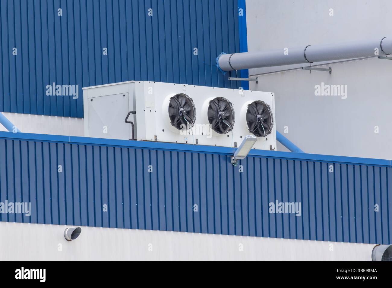 Large air conditioning units are mounted on the roof of a modern ...