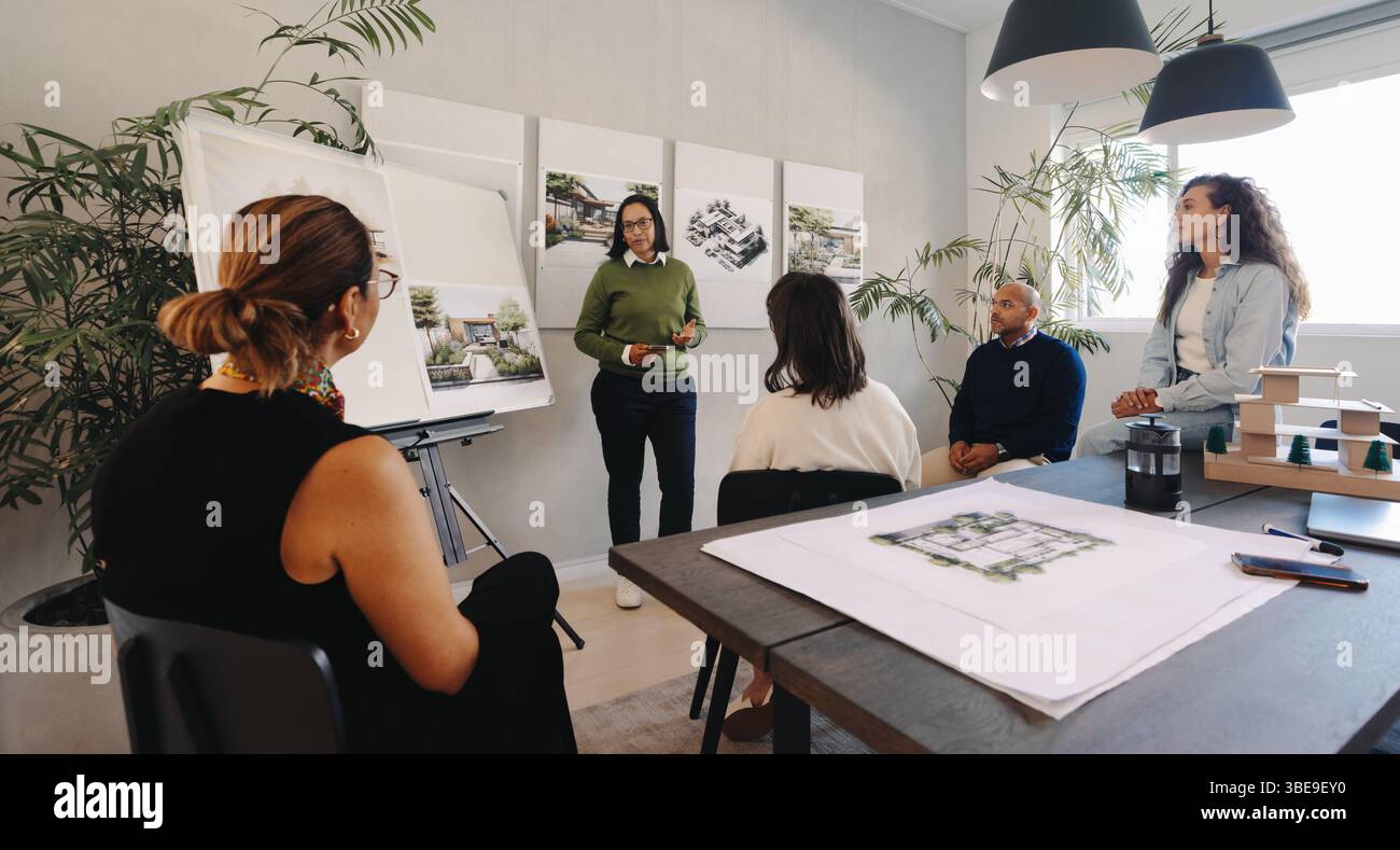 A group engages in a team meeting focused on project scope and planning ...