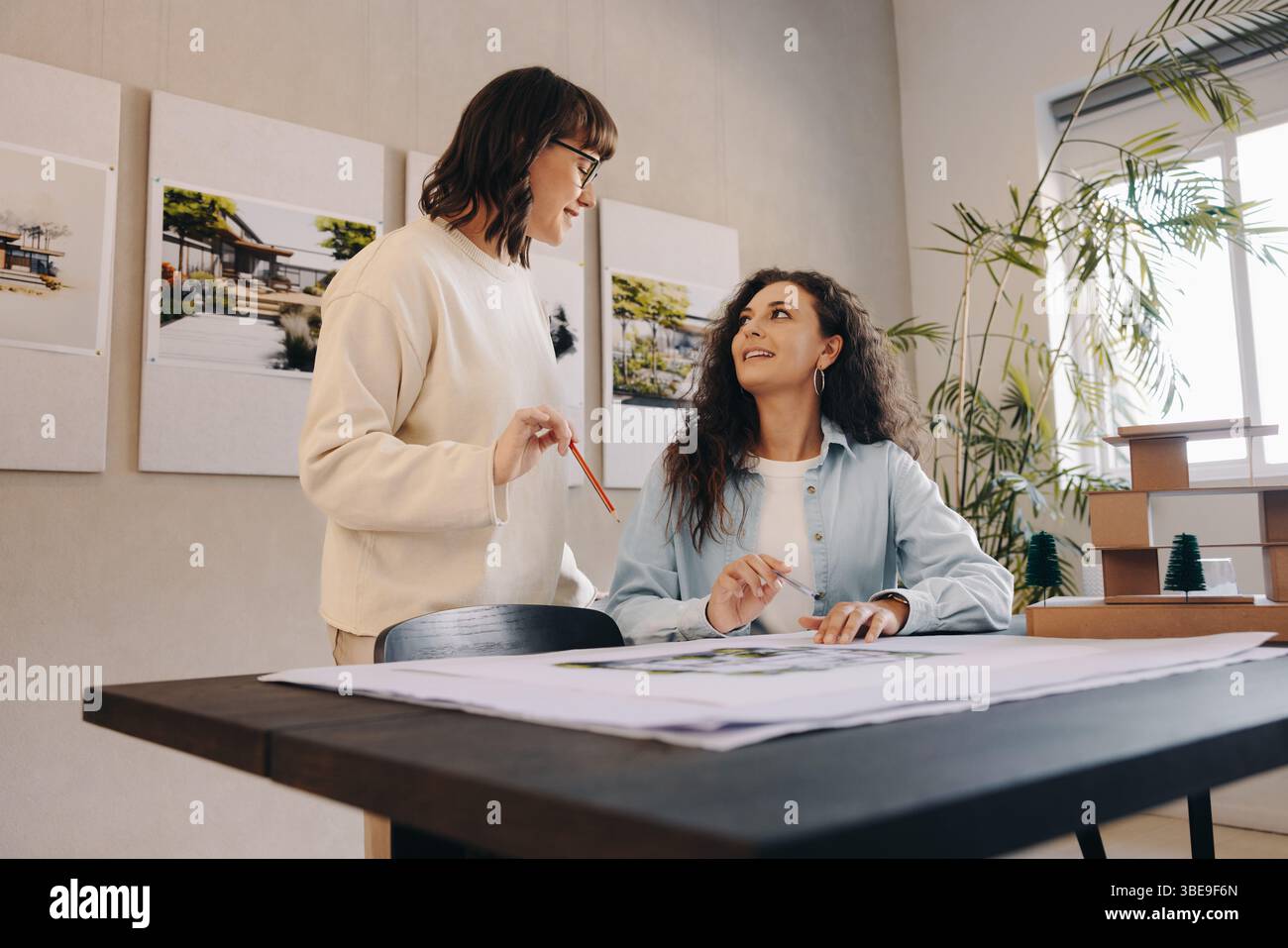 Two female professionals discuss and plan a project in an innovative ...