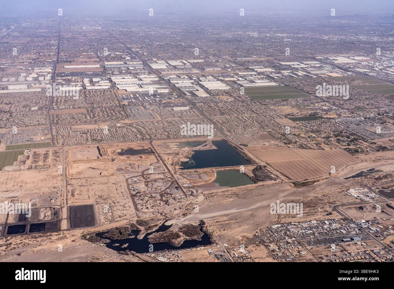 Aerial view of gravel pits, residential areas and a large industrial ...