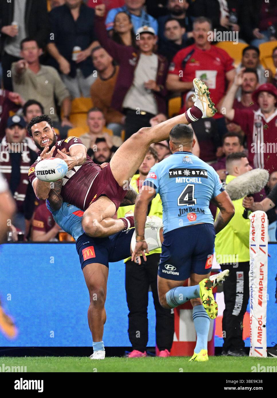 Xavier Coates of the Maroons is tackled in the air by Brian To’o of the ...