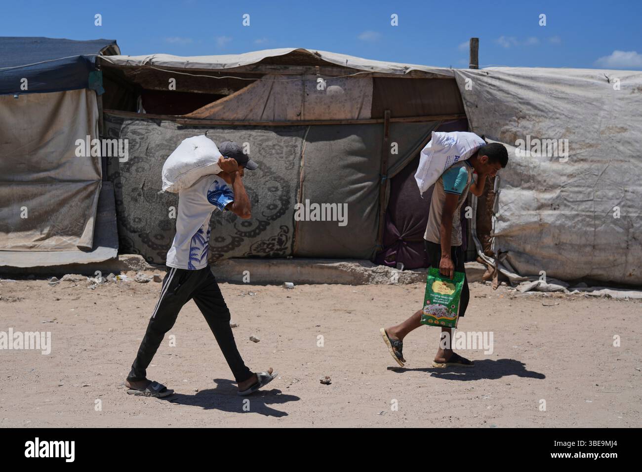 Palestinians carry food and humanitarian aid delivered by the U.S ...