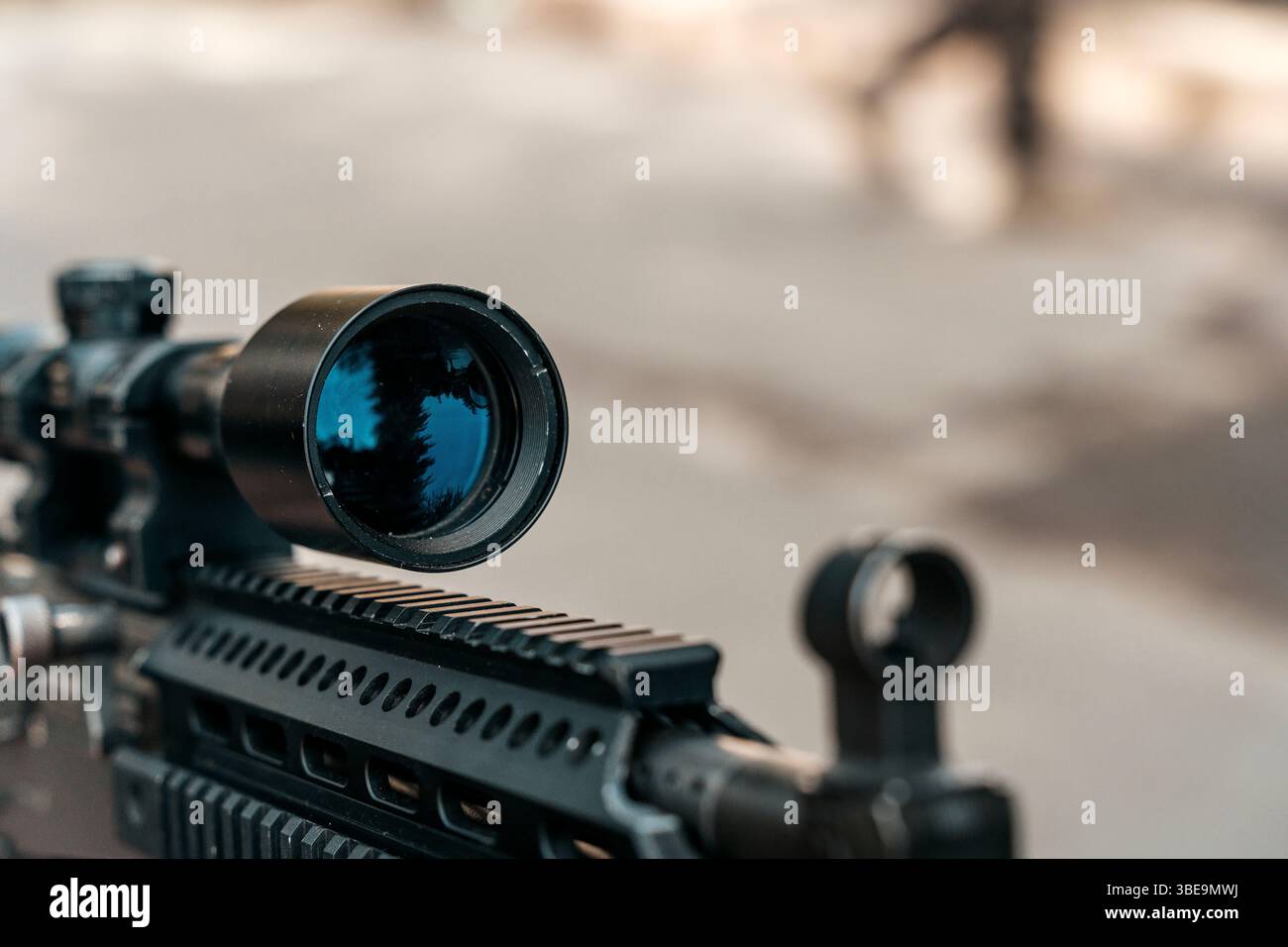 Detailed close-up of a modern tactical rifle with an optical scope. The ...