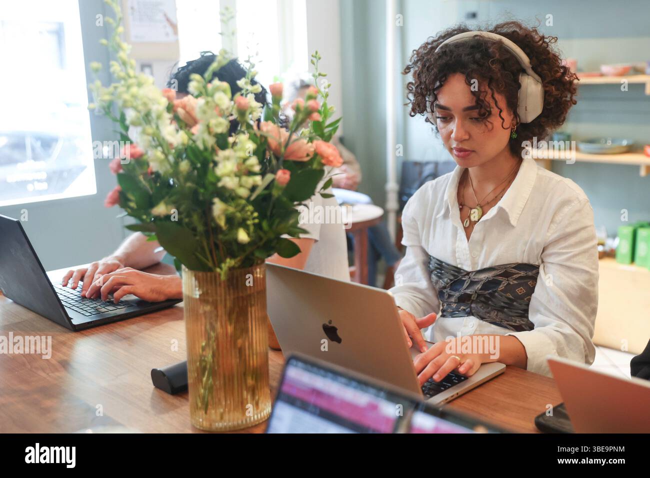 Summer Dean, 27, works inside a coffee shop, Friday, May 23, 2025, in ...