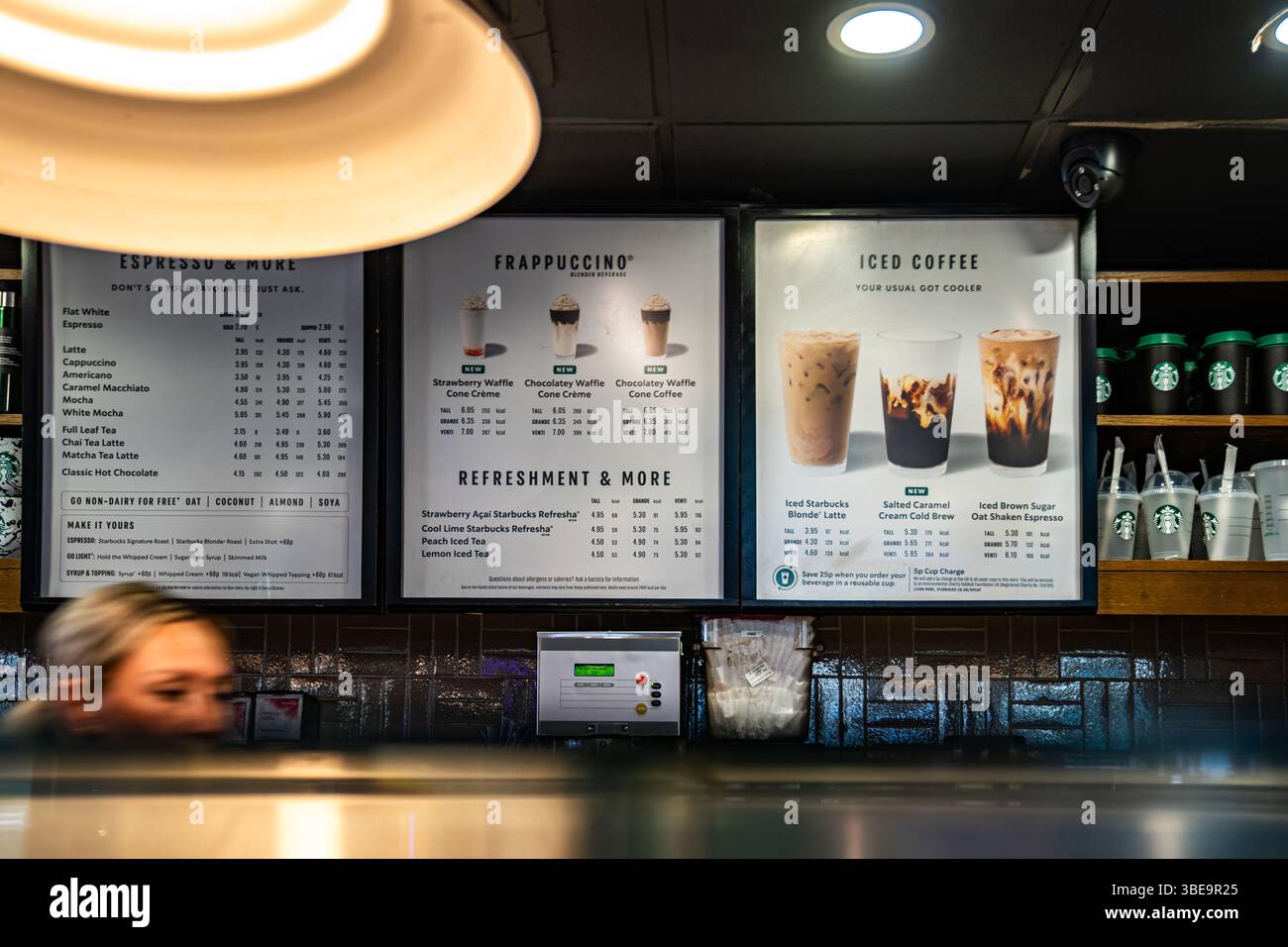 London, England, 12 July 2023, Starbucks Menu Board Displayed Behind the Counter Featuring ...