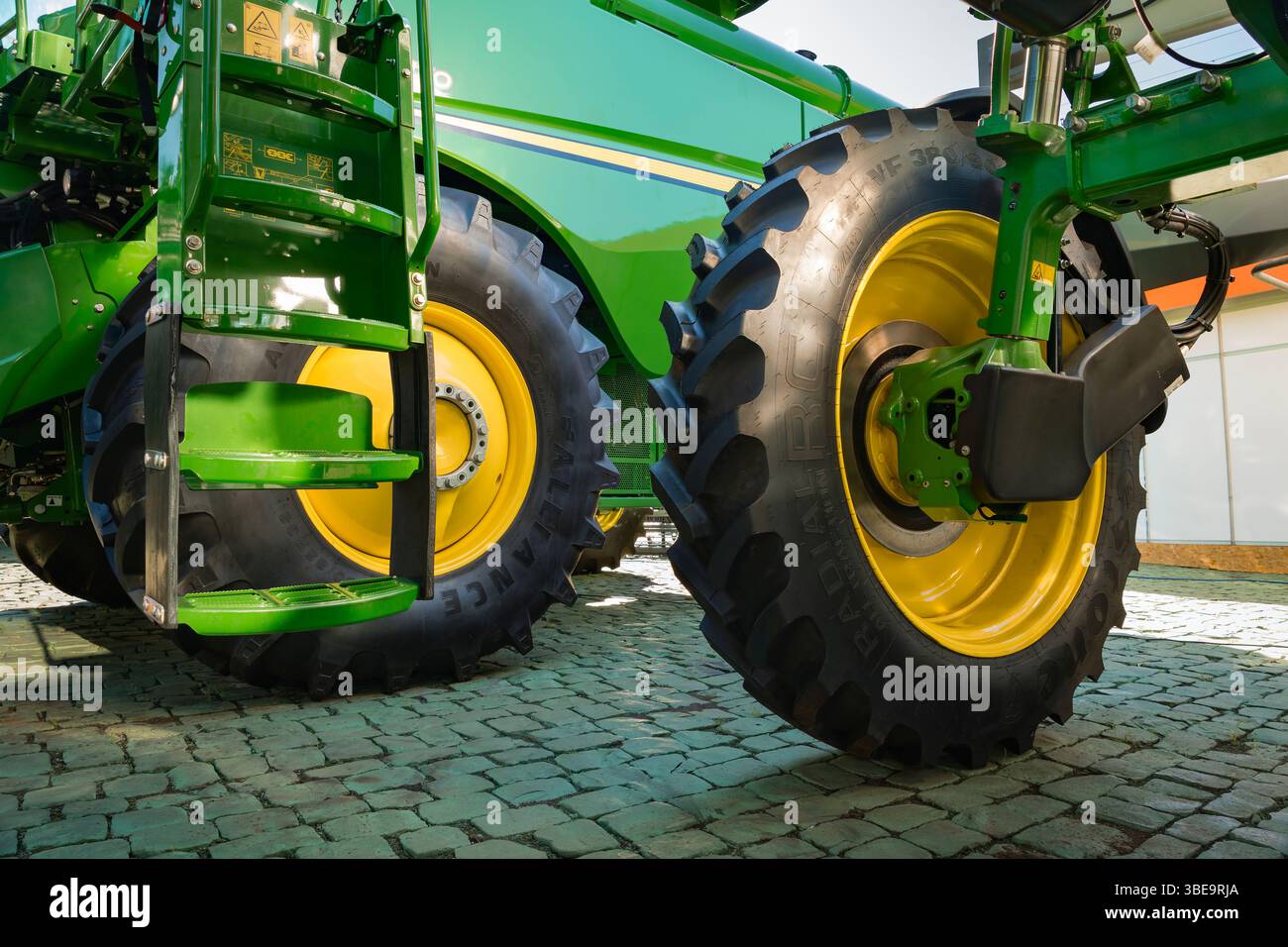 Underside of a large John Deere agricultural machine with wide tires ...