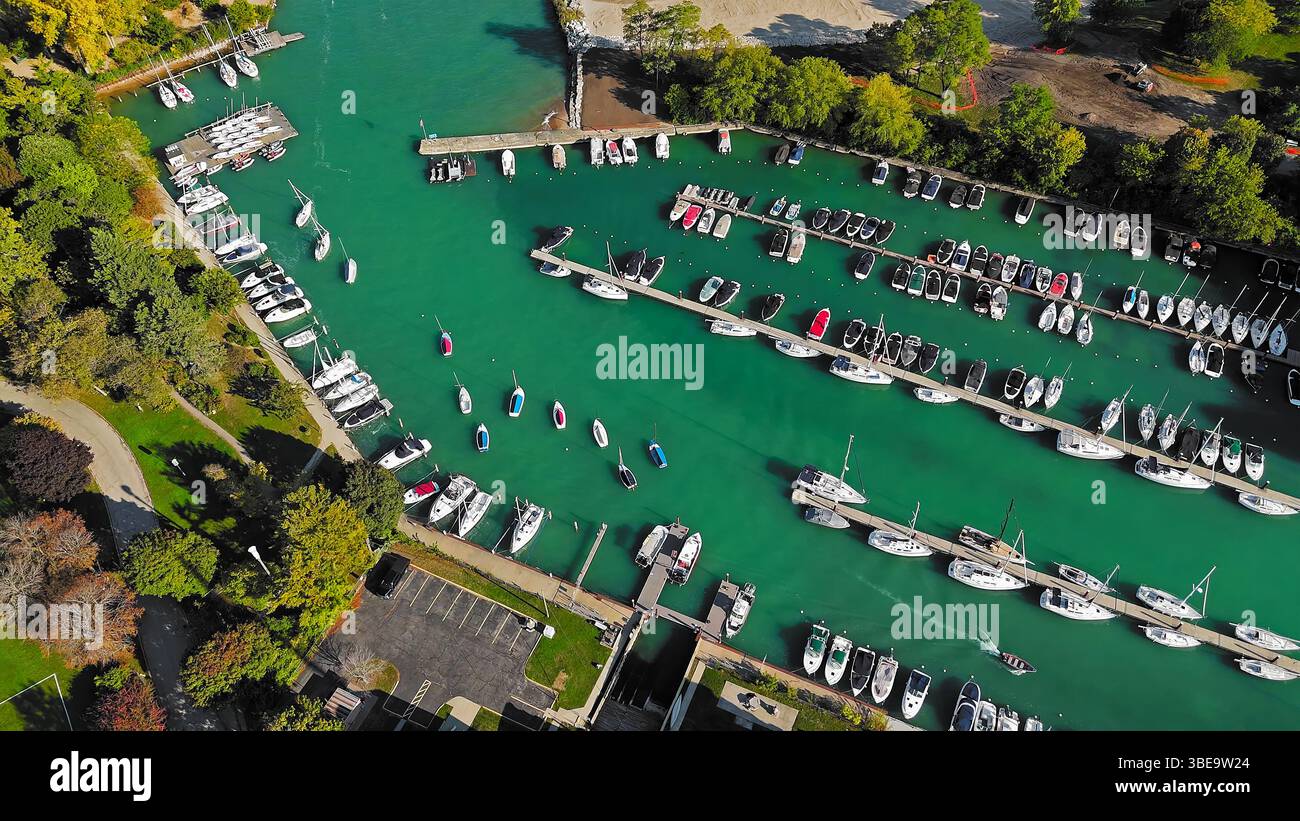 Aerial view of marina with docked boats. An aerial view showcases a ...