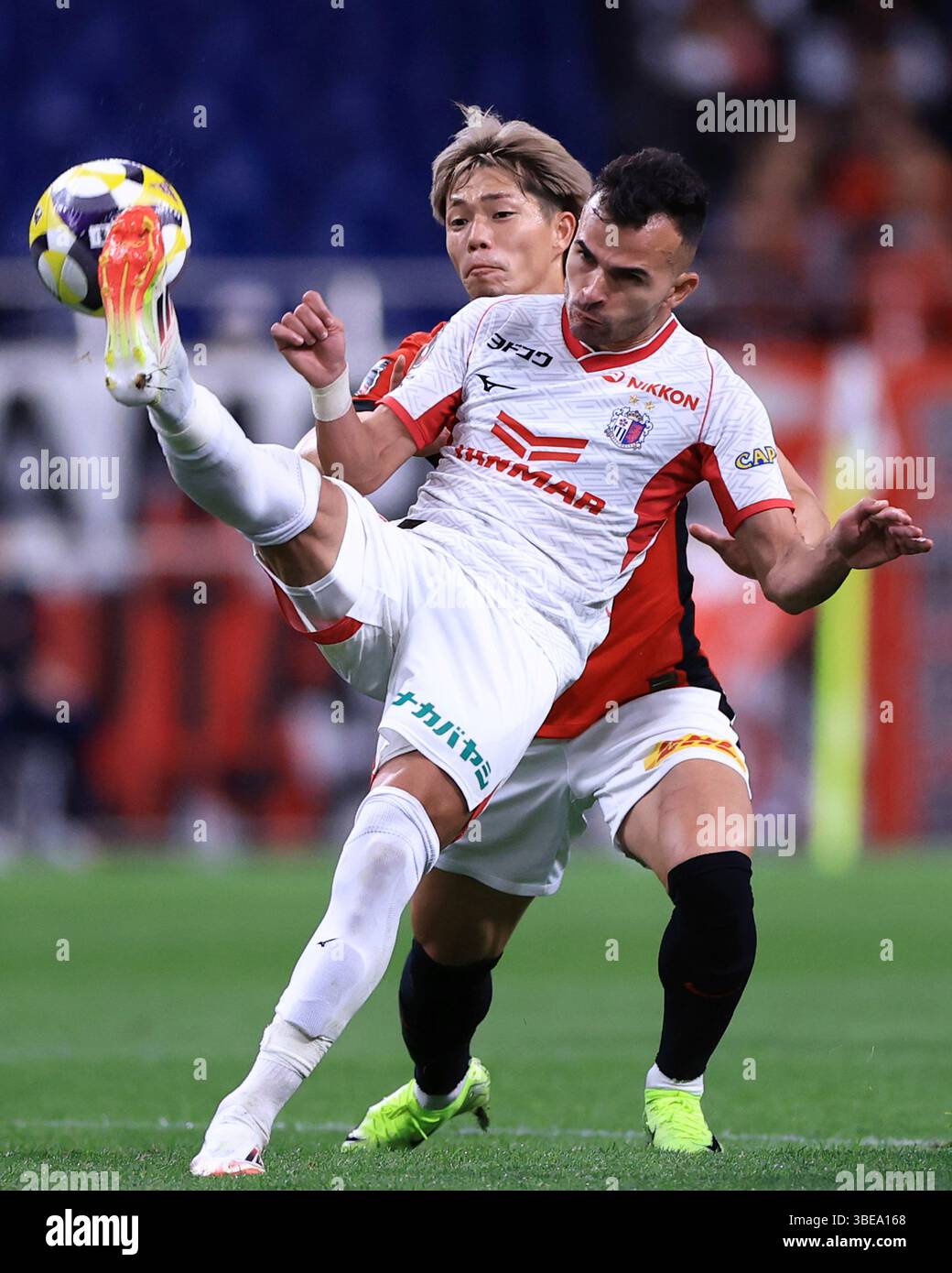 Cerezo Osaka's Lucas Fernandes (front) competes with an Urawa Red ...