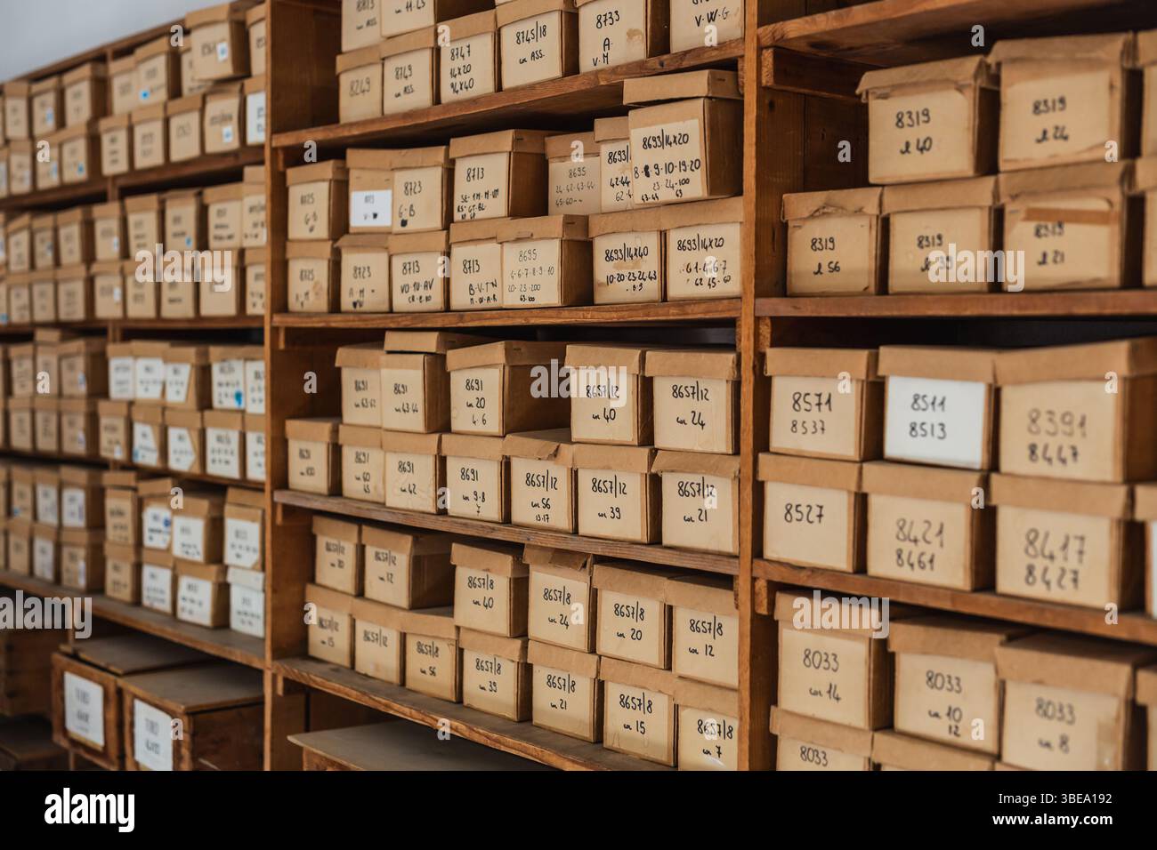 cardboard boxes, some with handwritten labels and sequential numbers ...